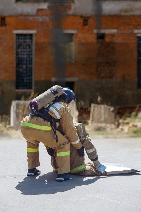 Fireman in Uniform is Dragging a Mannequin on Training Stock Photo ...