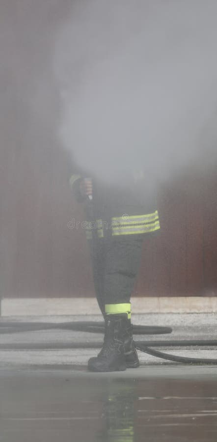 Fireman Uses a Fire Hydrant To Put Out a Fire Stock Photo - Image of ...