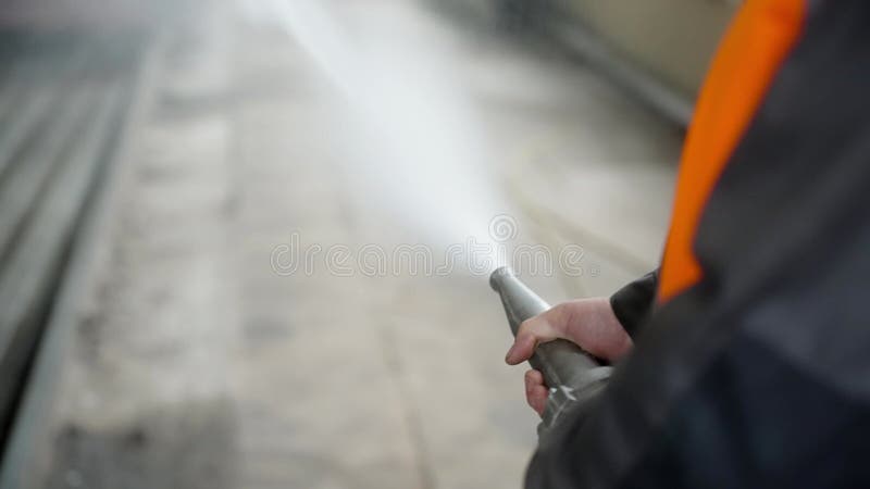 Fireman Using a High Pressure Hose for Fire Fighting, Pouring Water ...