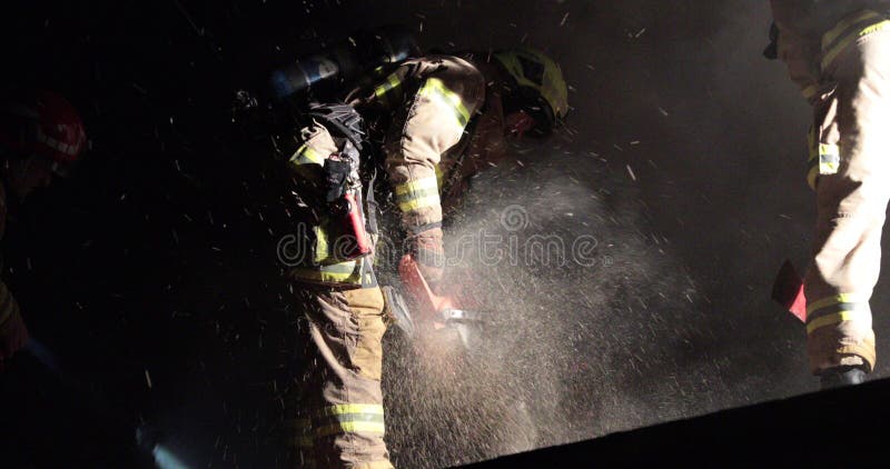 Fireman Using Saw for Ventilation on Involved Roof. Stock Footage ...
