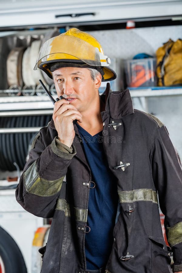 Fireman Using Walkie Talkie at Fire Station Stock Image - Image of ...