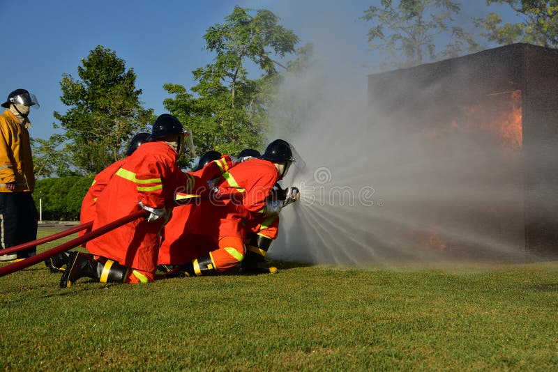 Fireman Watering Against Fire Stock Photo - Image of firefighter ...
