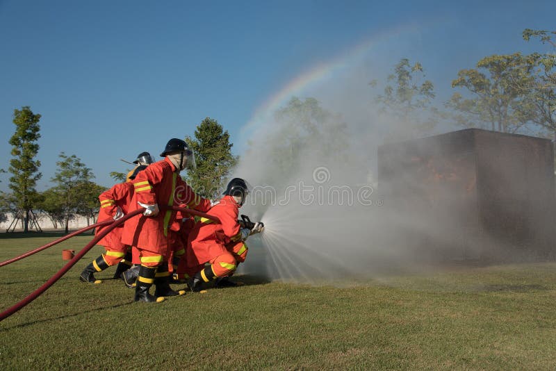 Fireman Watering Against Fire Stock Photo - Image of firefighter ...