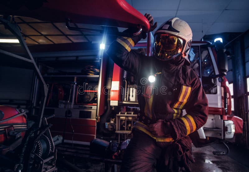 A Fireman Wearing a Protective Uniform with Flashlight Included Working ...