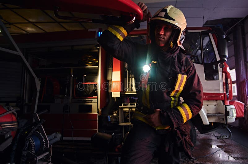 A Fireman Wearing a Protective Uniform with Flashlight Included Working ...