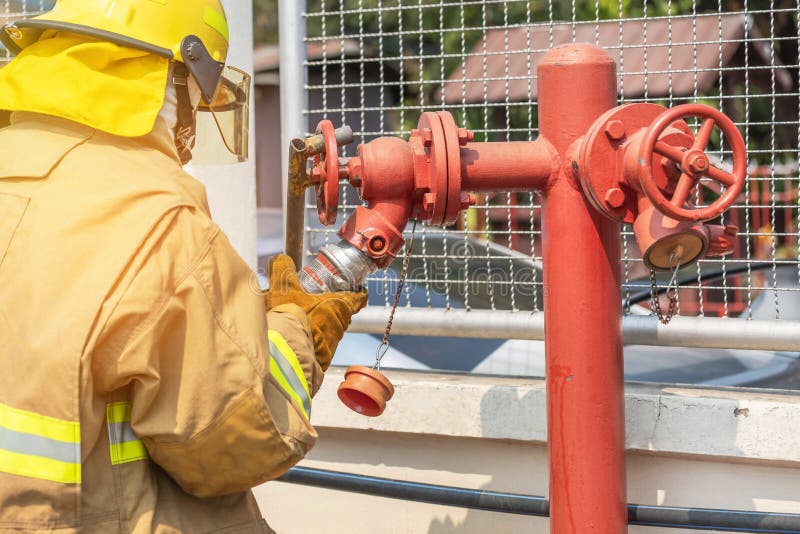 Fireman in Yellow Fire Fighter Uniform during Connect Firehose Tube in ...