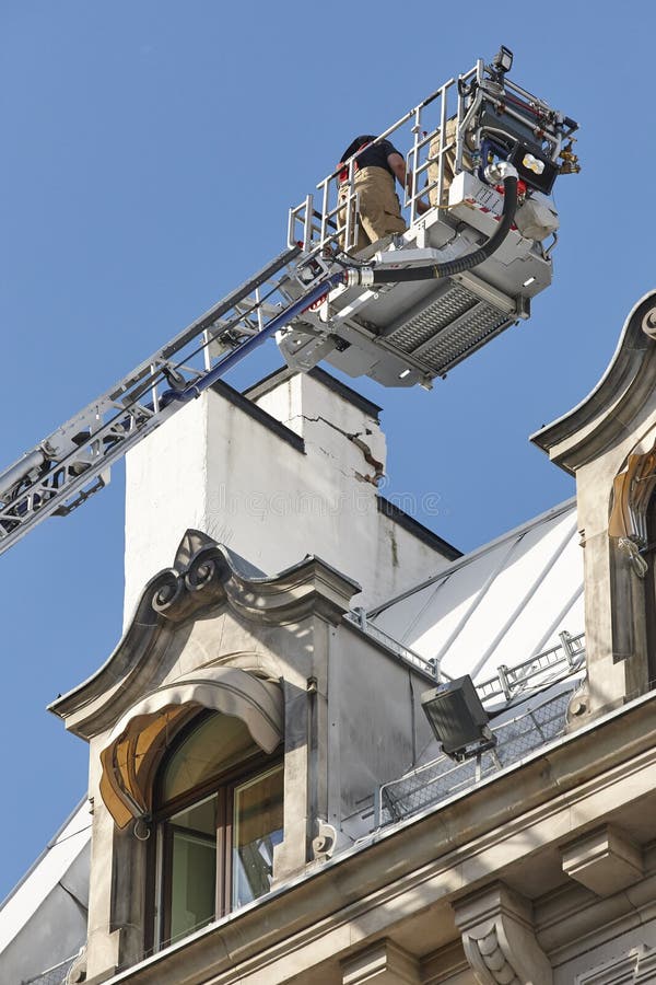 Firemen on a Crane Fixing a Structural Building Fissure Stock Photo ...