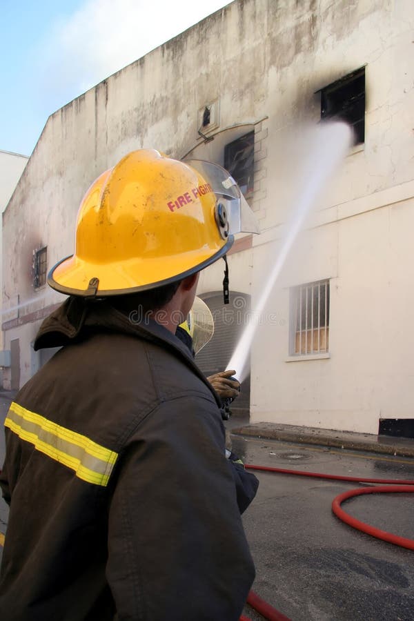 Fireman fighting a fire stock image. Image of visor, claim - 5158405