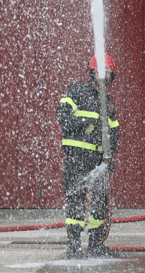 Firemen with hose hydrant stock photo. Image of jeopardy - 163452090