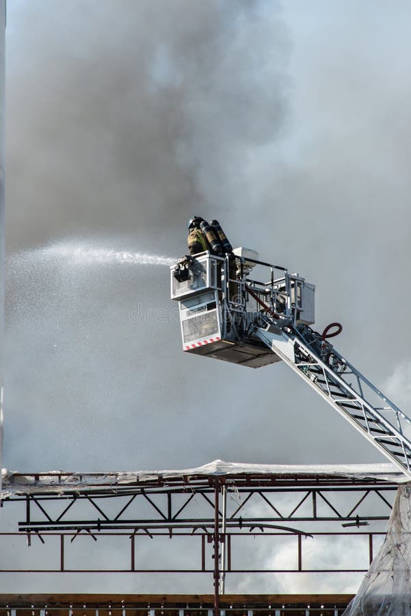 Firemen on a lift up stock photo. Image of extinguisher - 15782664