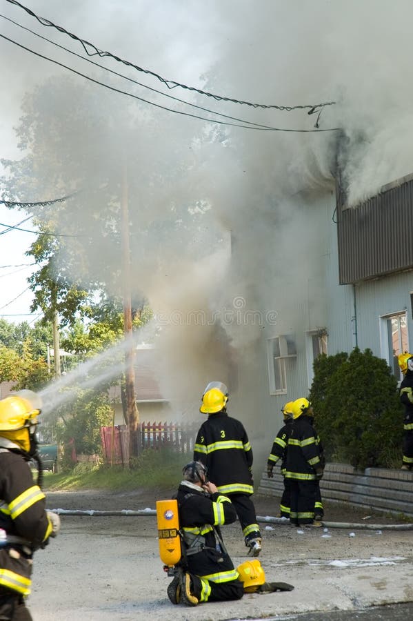 Firemen on the move stock image. Image of fight, hose - 1460377
