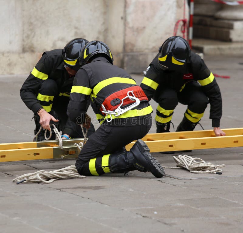 Firemen during Rescue Operations with a Wooden Ladder Stock Photo ...