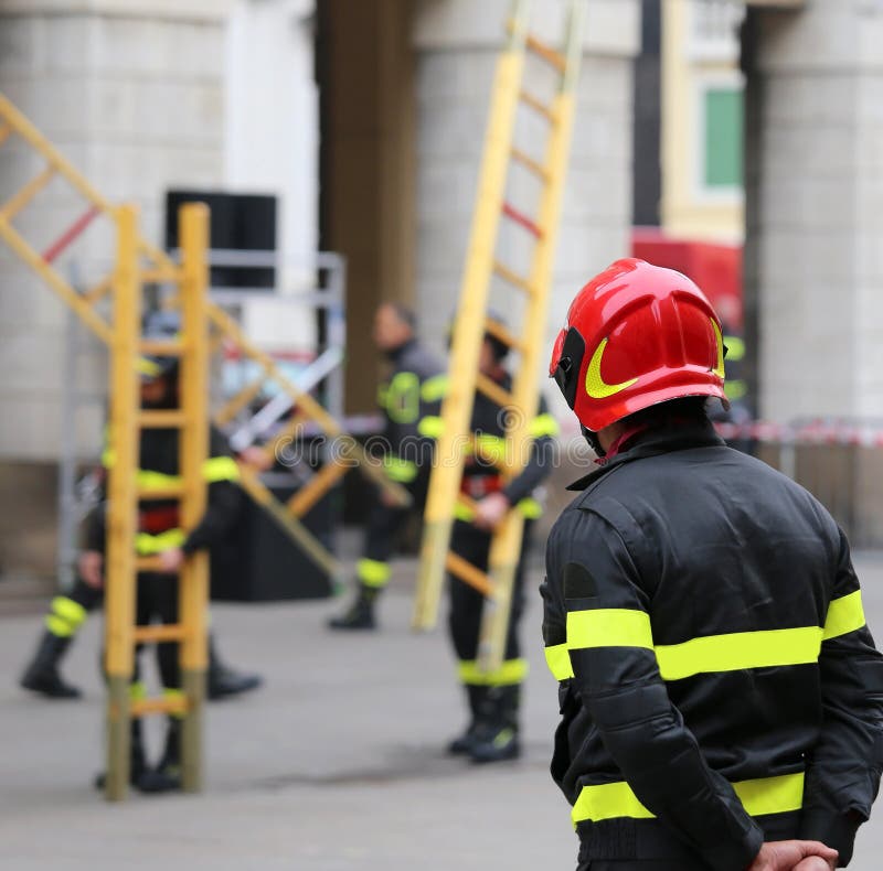 Firemen during Rescue Operations with a Wooden Ladder Stock Image ...