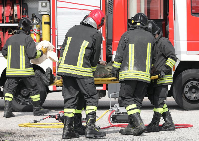 Firemen with the Stretcher and the Injured after the Road Accide Stock ...
