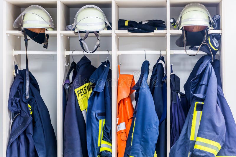 Firemen suits and helmets stock image. Image of work - 100686569
