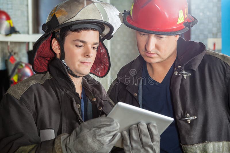 Firemen Using Digital Tablet at Fire Station Stock Image - Image of ...