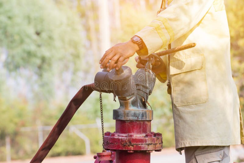 Firemen Using Water from Hose for Fire Fighting at Fire Fight Tr Stock ...