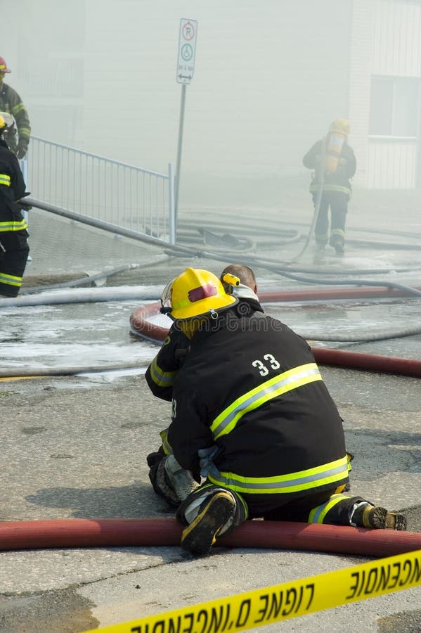 Firemen at work 6 stock photo. Image of glow, firemen - 1182902