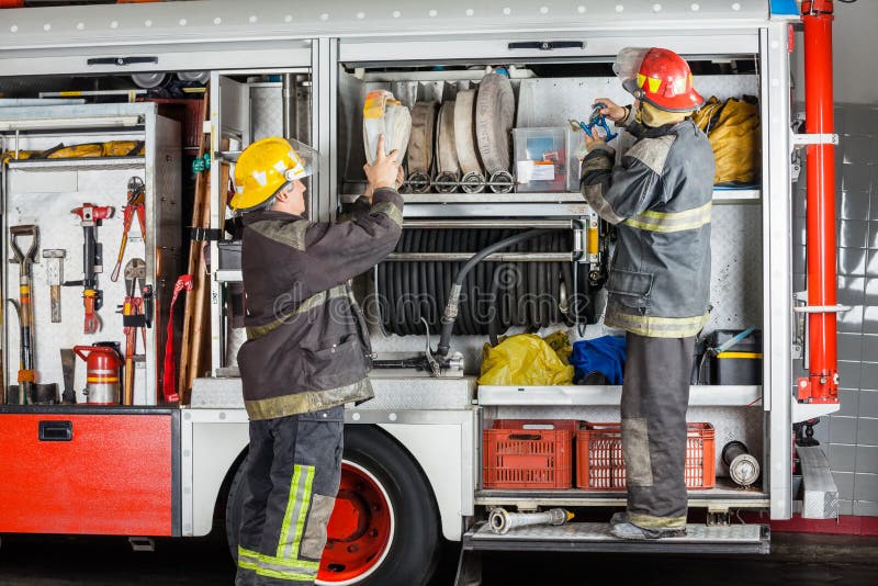 Firemen Working at Truck in Fire Station Stock Image - Image of adult ...