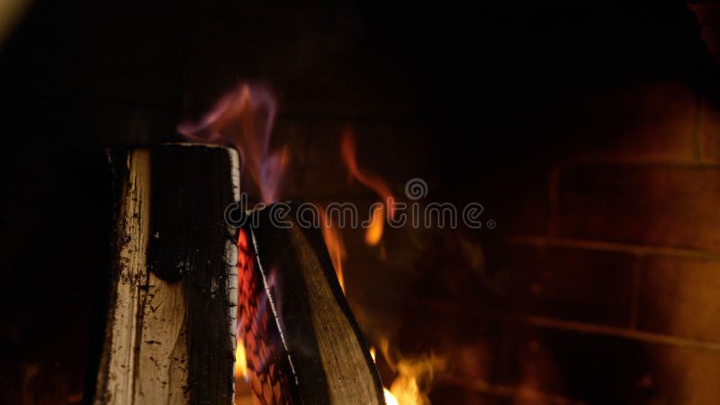 Two Logs are Burning in the Fireplace, Close-up. a Fireplace Where Wood ...