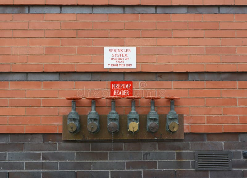 Firepump Test Headers on Red Brick Wall Stock Image - Image of urban ...