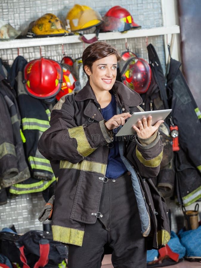Firewoman Looking Away while Using Digital Tablet Stock Photo - Image ...
