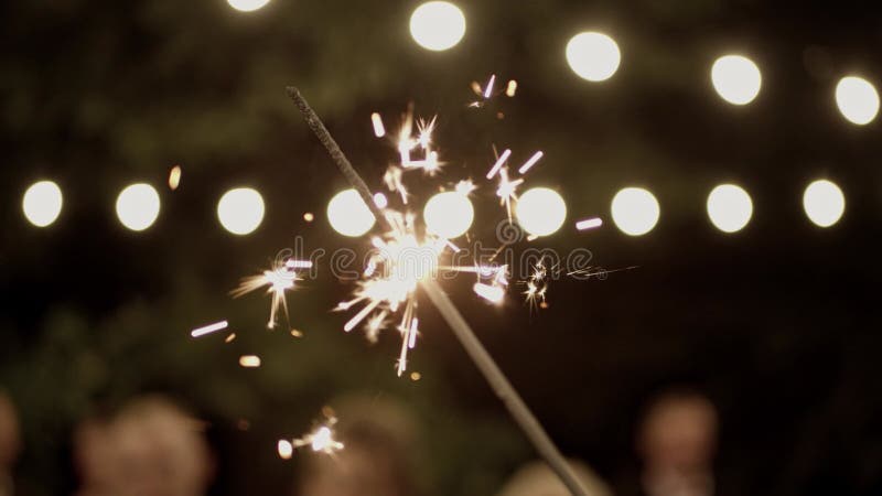 Firework Sparkler Burning with Lights in Background. Stock Video ...
