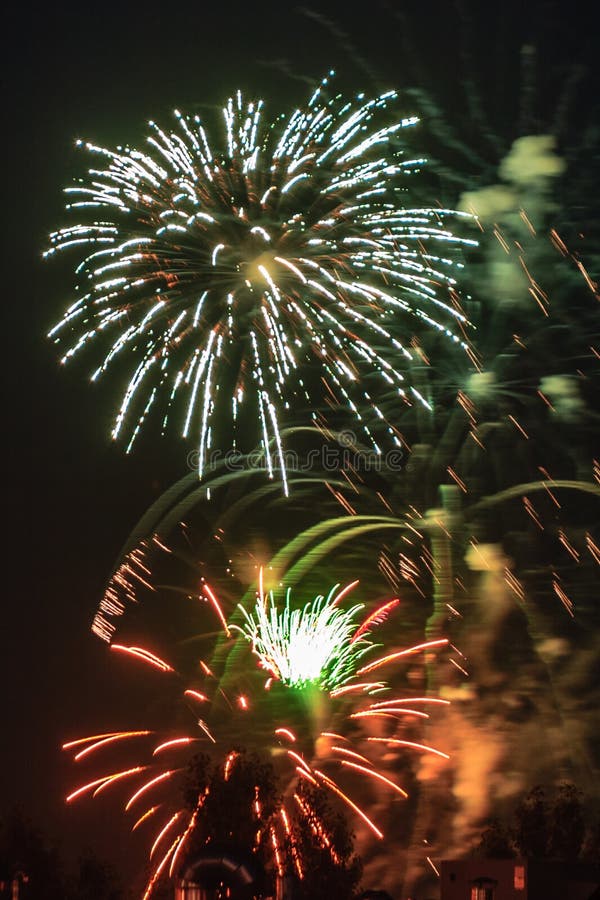 A Fireworks Display with Green and Red Fireworks Stock Image - Image of ...