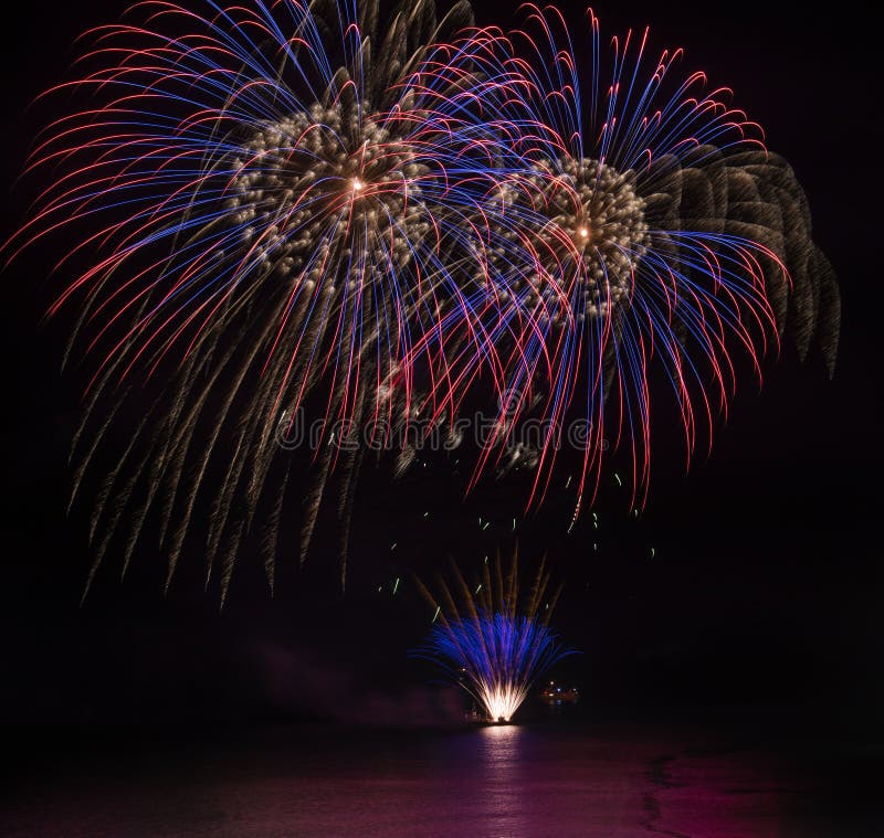 Fireworks Display Over Sea with Reflections in Water Stock Photo ...