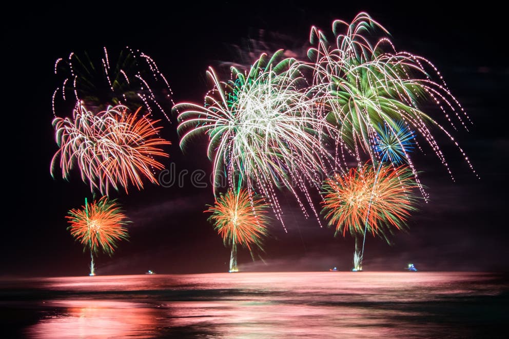 Fireworks Exploding Over the Ocean at Night Stock Photo - Image of ...