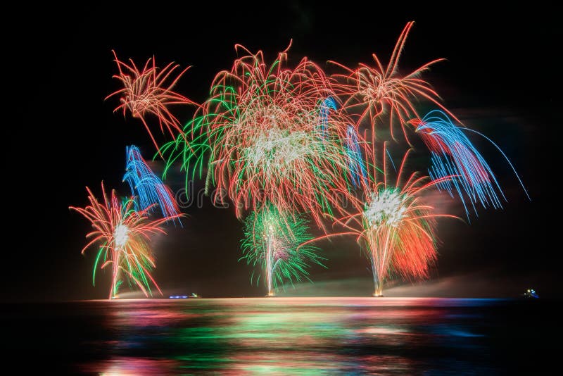 Fireworks Exploding Over the Ocean at Night Stock Photo - Image of ...