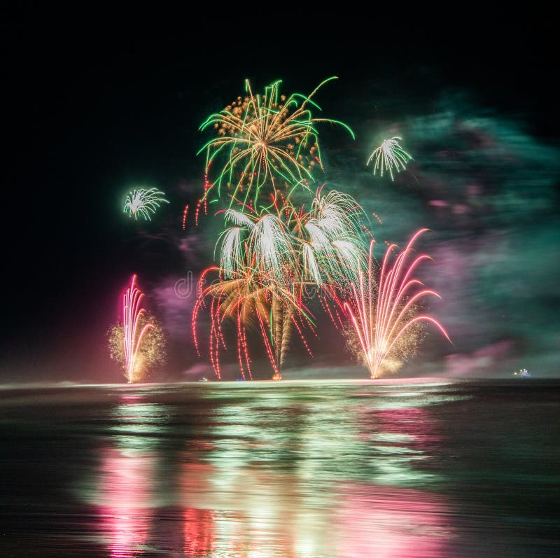 Fireworks Exploding Over the Ocean at Night Stock Photo - Image of ...