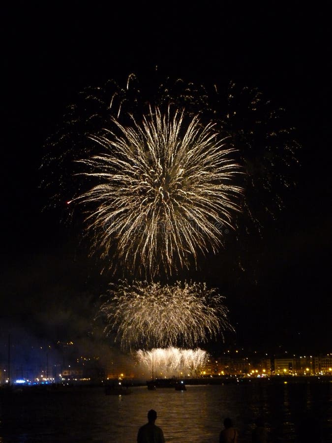 Fireworks Exploding Over the Ocean at Night Stock Photo - Image of ...