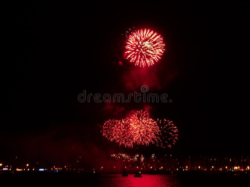 Fireworks Exploding Over the Ocean at Night Stock Photo - Image of ...