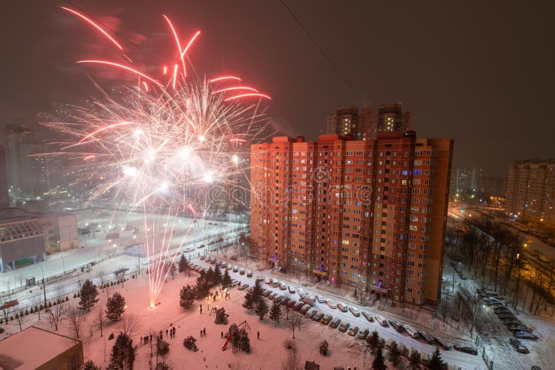 Fireworks Exploding Over Snowy Residential District at Night Stock ...