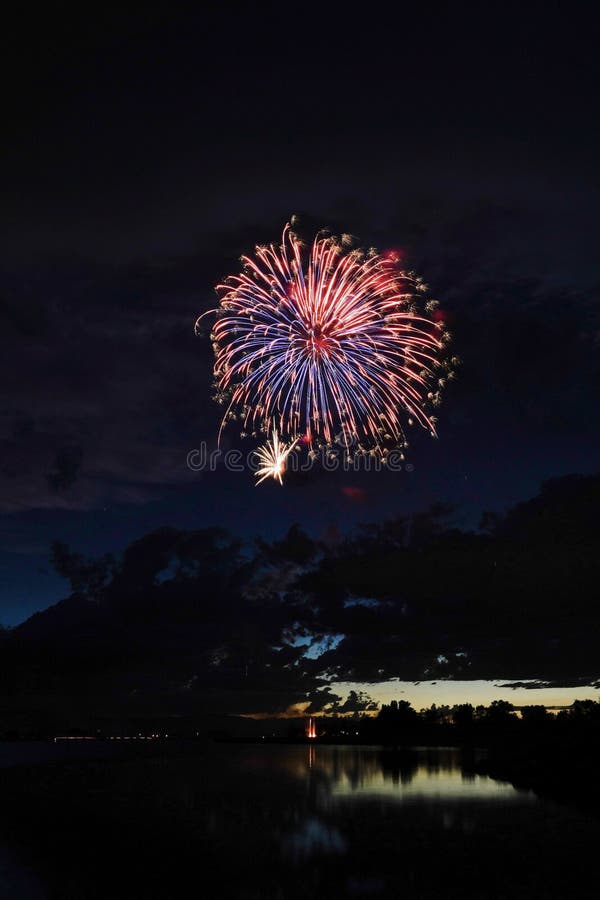 Some Firework and Some Sky at Night by a Body of Water Stock Photo ...