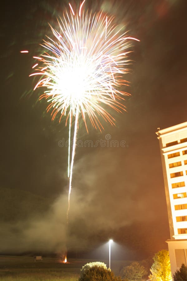 View of Fireworks Next To a Tall Building Stock Image - Image of ...