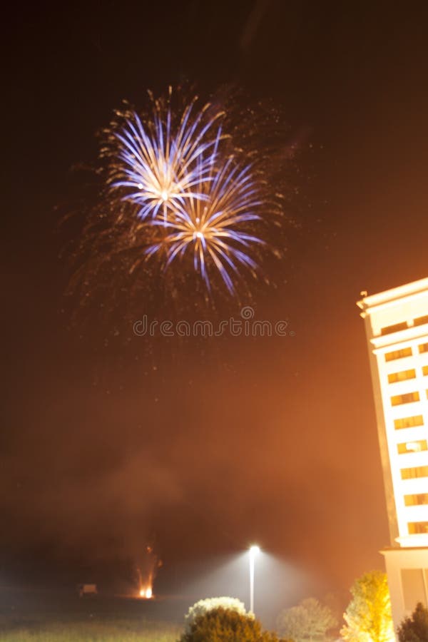 View of Fireworks Next To a Tall Building Stock Photo - Image of ...