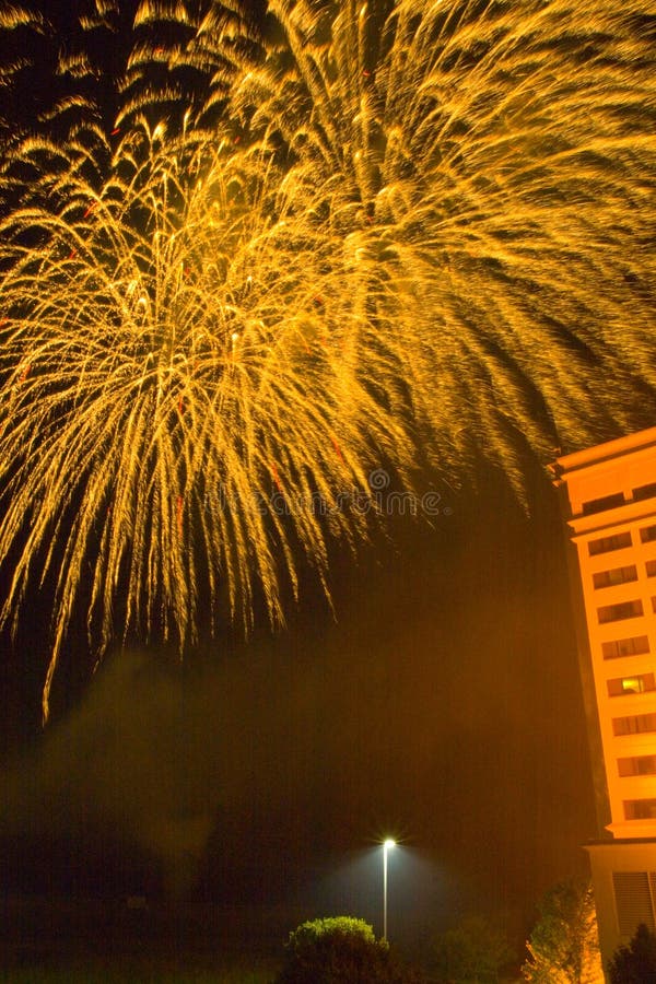 View of Fireworks Next To a Tall Building Stock Photo - Image of ...