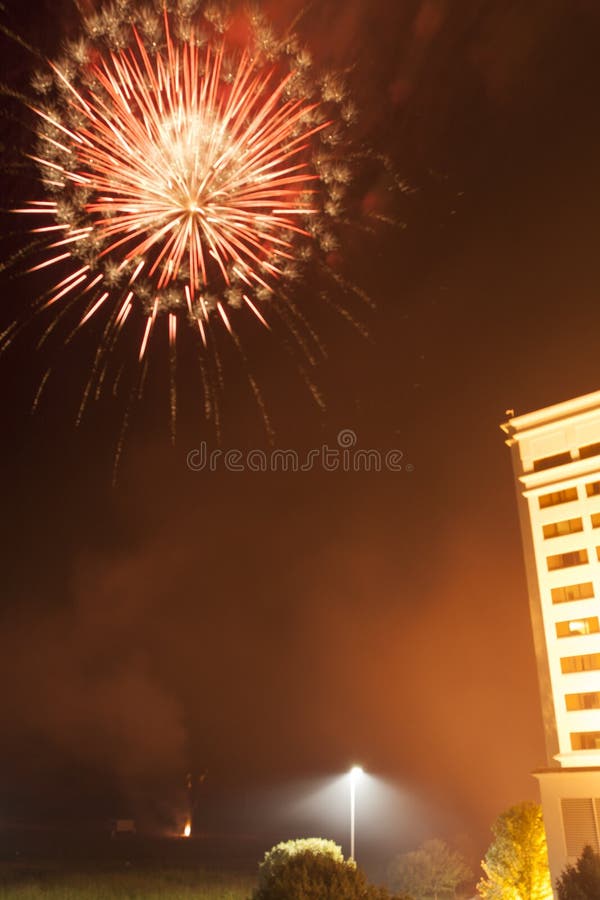 View of Fireworks Next To a Tall Building Stock Photo - Image of ...