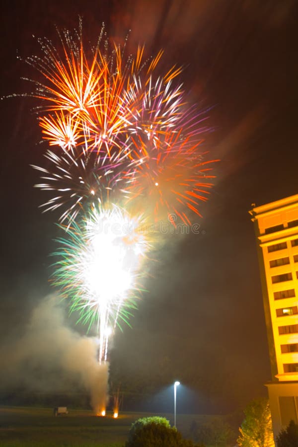 View of Fireworks Next To a Tall Building Stock Image - Image of tall ...
