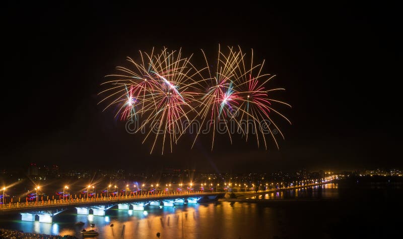 Fireworks Over the City in Large River with Bridge in Lights Stock ...