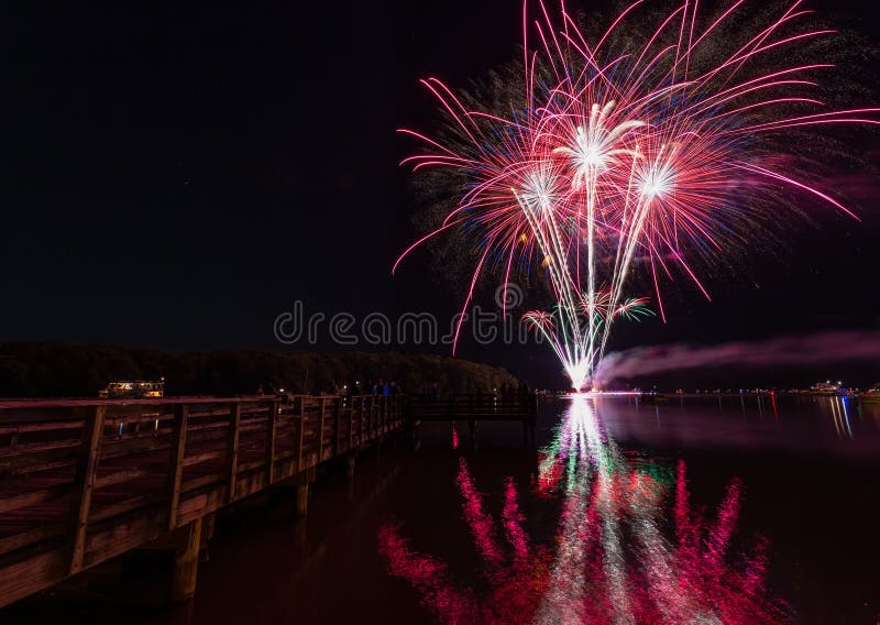 Fireworks Over a Lake and Dock Stock Photo - Image of darkness, park ...
