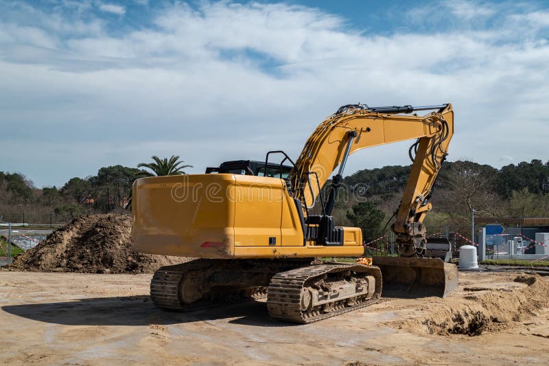 Firm Foundations: Backhoe Prepares the Land for Construction Stock ...
