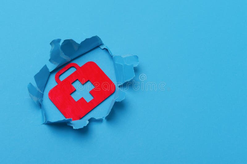 First Aid Bag Sign in Paper Cut Hole. Blue Background Stock Photo ...
