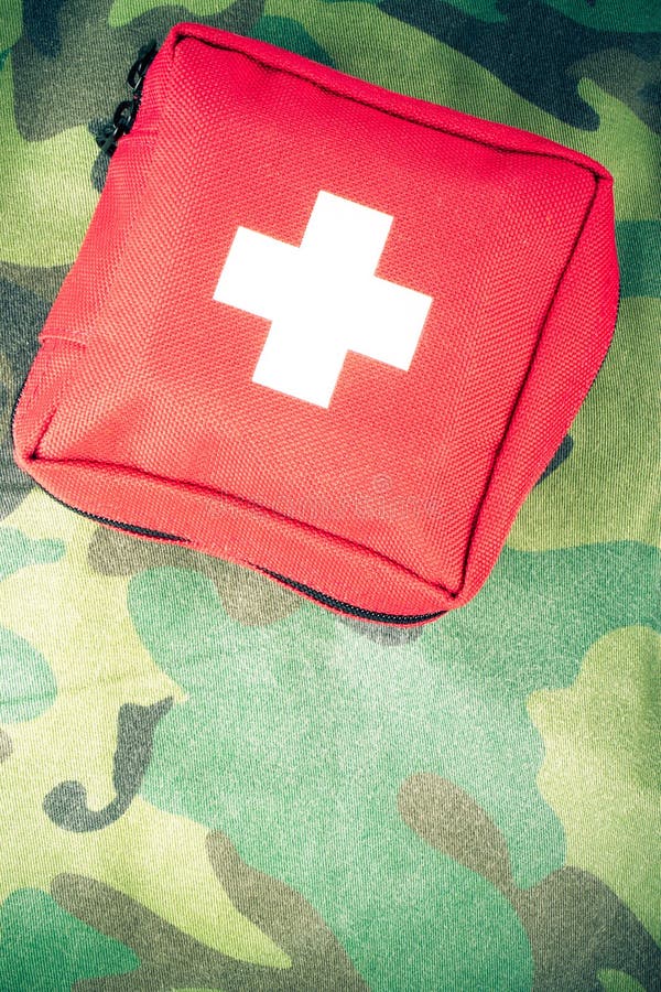First Aid Kit on a Fabric with Camouflage Pattern. Toned Stock Image ...