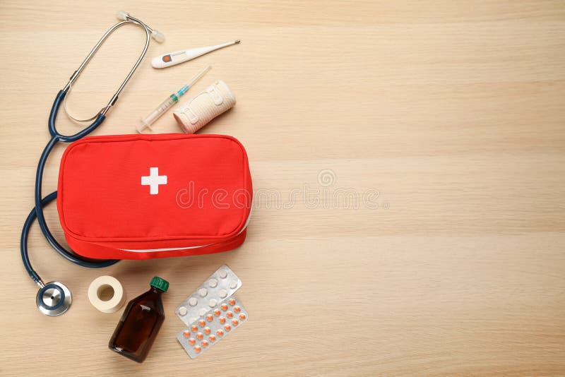 First Aid Kit on Light Wooden Table, Flat Lay. Space for Text Stock ...