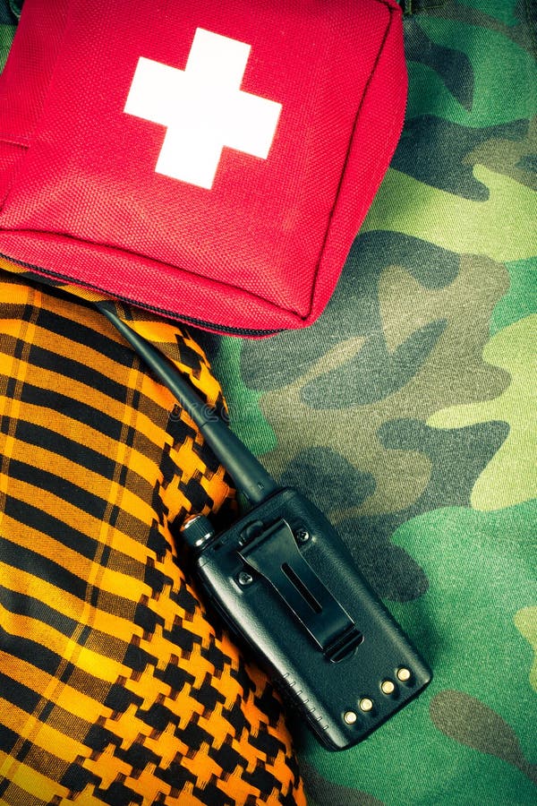 First Aid Kit and Portable Radio on a Fabric with Camouflage Pat Stock ...