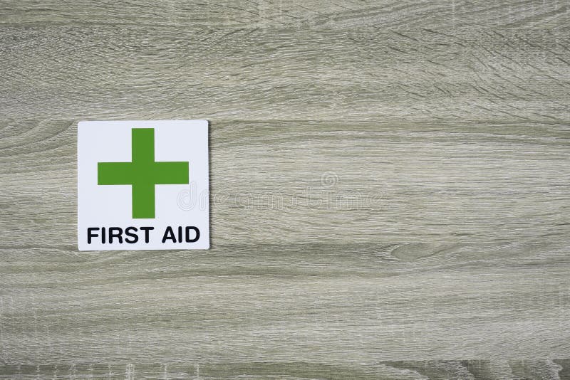 First Aid Sign on the Wooden Wall with Space for Adding Text on the ...