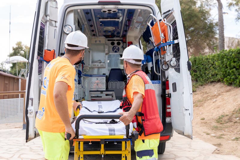 First Aid Team with Uniform Using a Stretcher from an Ambulance Stock ...